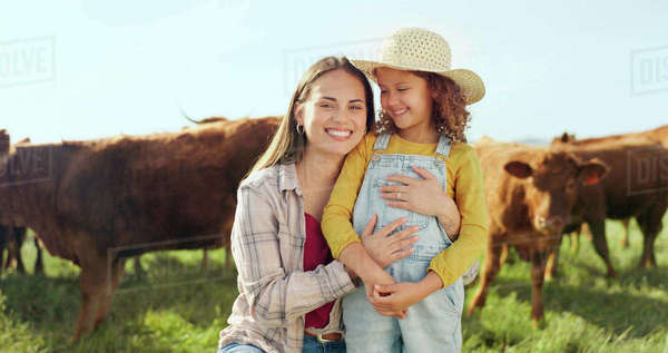 Portrait, farm and a mother hugging her daughter with cattle for ...