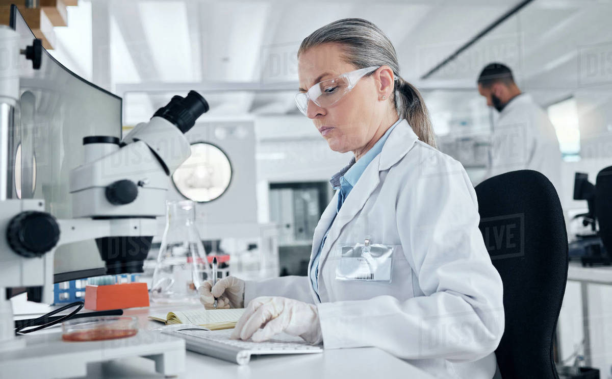 Laboratory, microscope and woman typing on computer for medical data ...