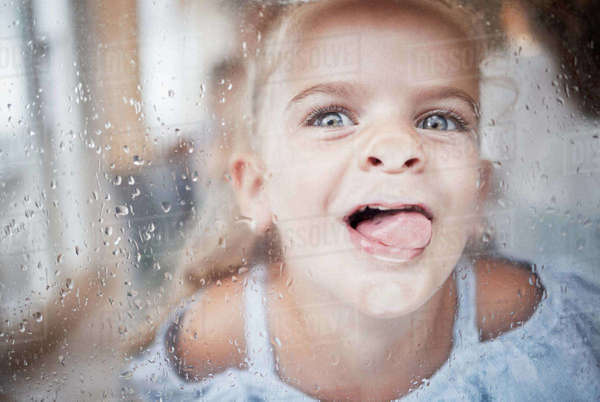 Funny, kid and tongue on window portrait with goofy and enthusiastic ...