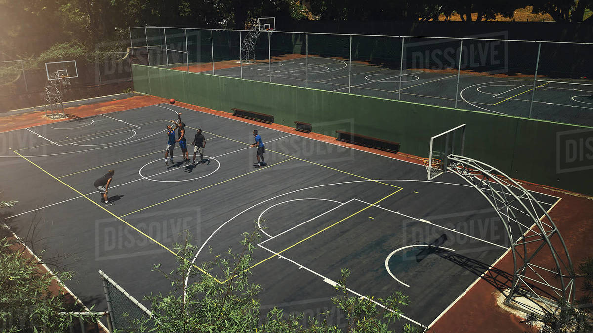 Basketball, outdoor court and athlete men showing energy in ball sports ...