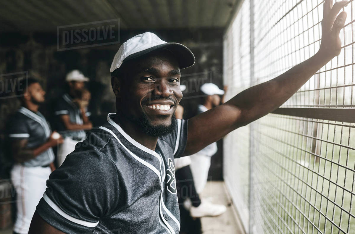 Baseball, training and portrait of coach in dugout, smile, relax and ...