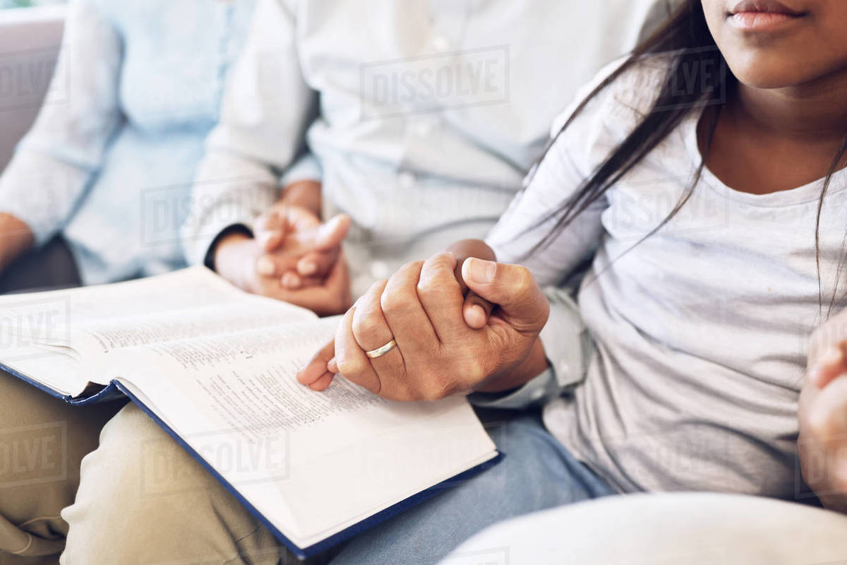 Worship, family and bible by father and kids holding hands and praying ...