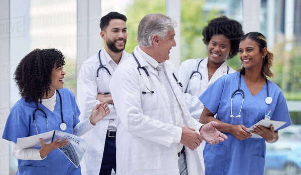 Doctors, nurses or laughing in hospital diversity, teamwork or ...