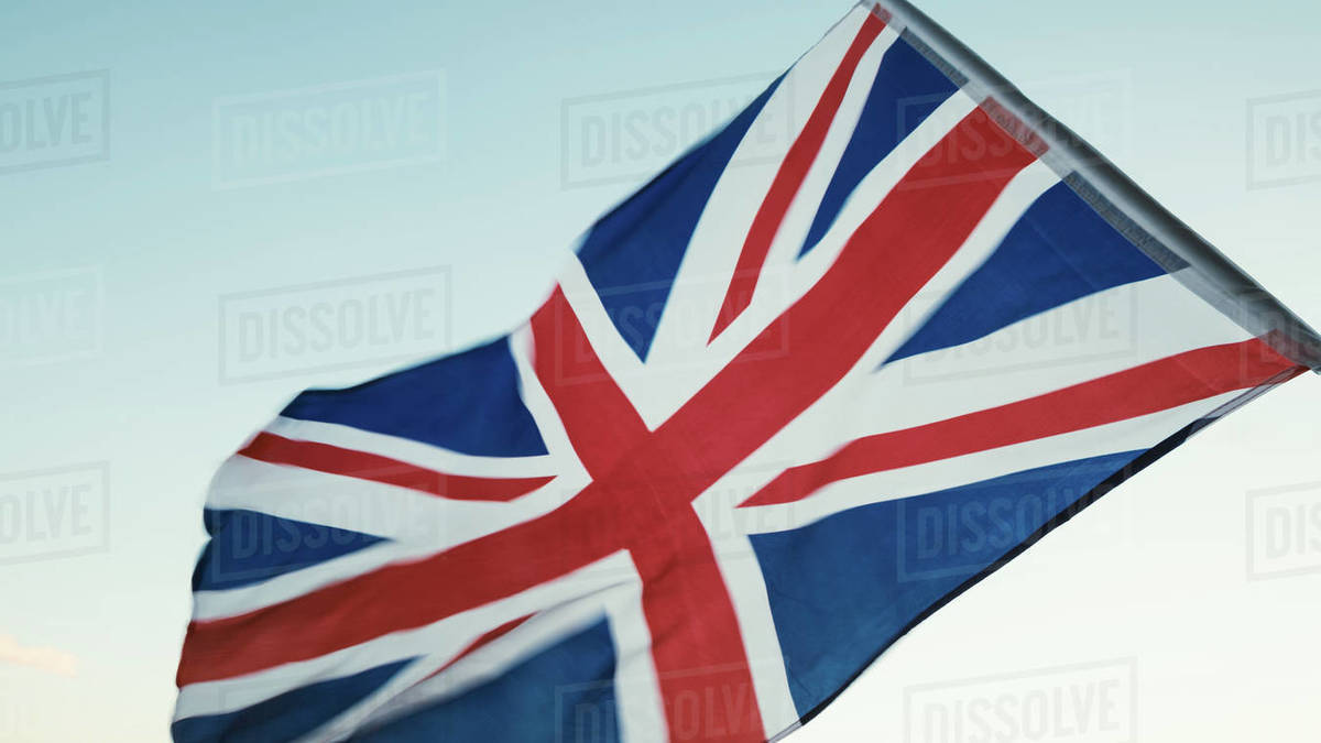 United Kingdom flag waving in the sky. - Stock Photo - Dissolve