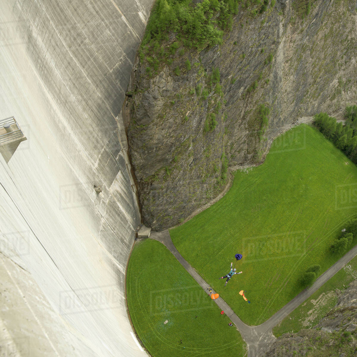 Man base jumping at the Contra dam in Ticino canton, Switzerland ...