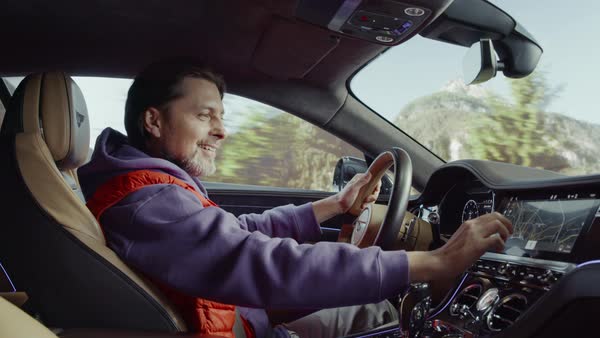 The driver behind the wheel looks at the map on the control panel. - 4K ...