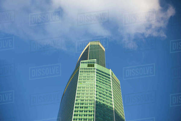 High-rise shopping center made of green glass. Modern building with ...