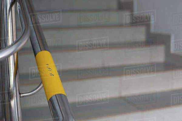 Information in braille text on handrails in building to help people ...