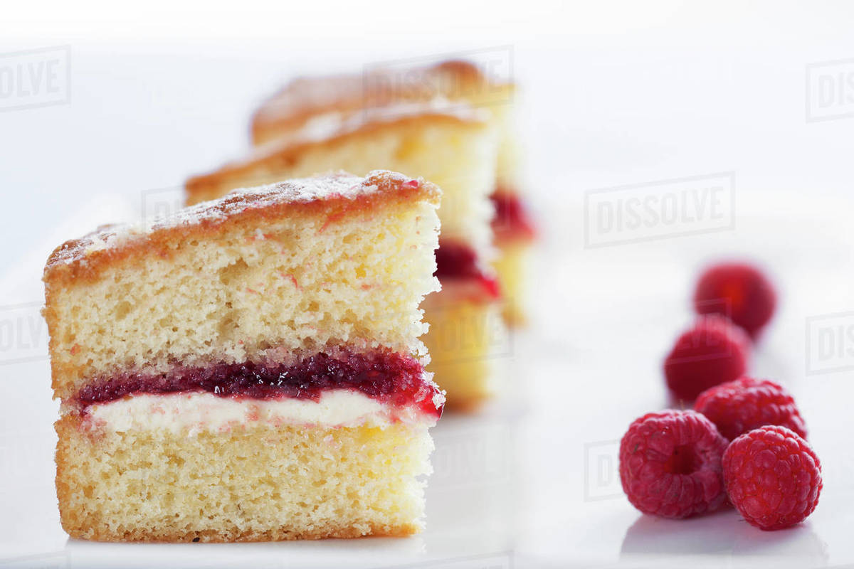 Victoria sponge cake with cream and jam filling, served with ...