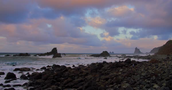 Towering rocks over Atlantic ocean. Rough waves splashing crash on ...