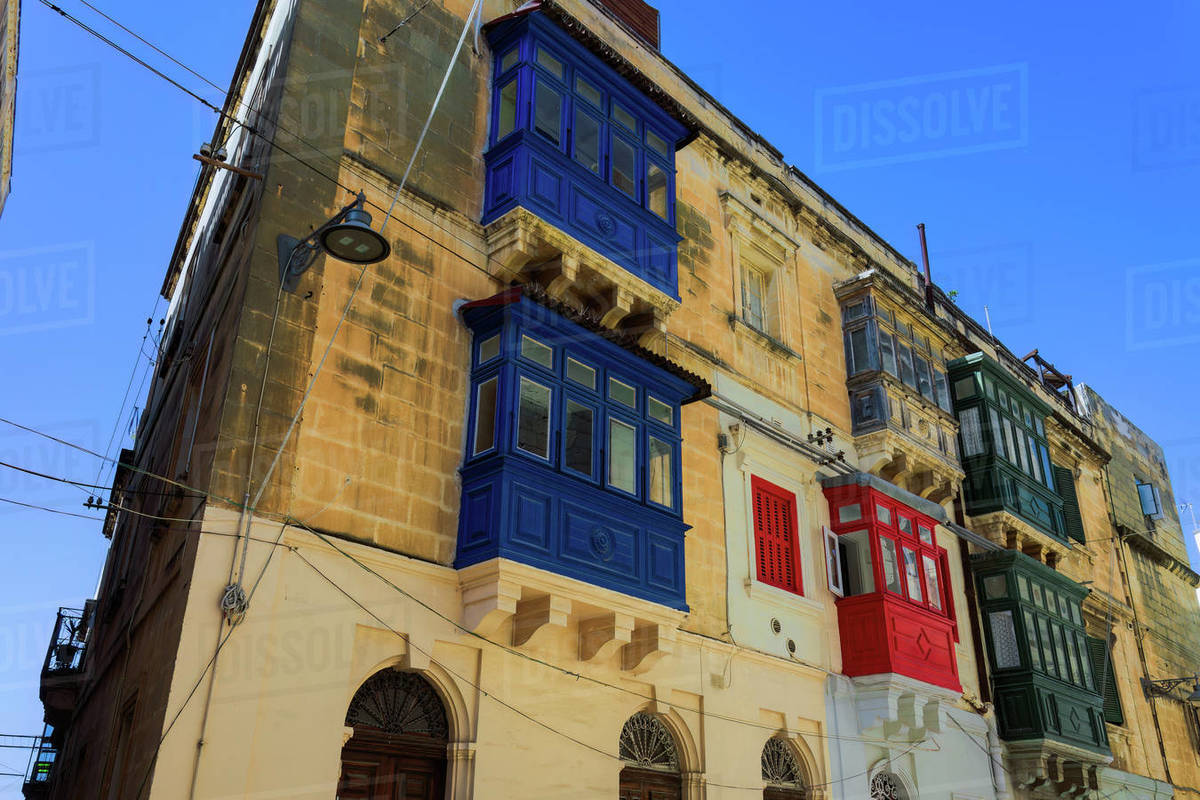 Traditional Maltese limestone buildings with coloured balconies in the ...
