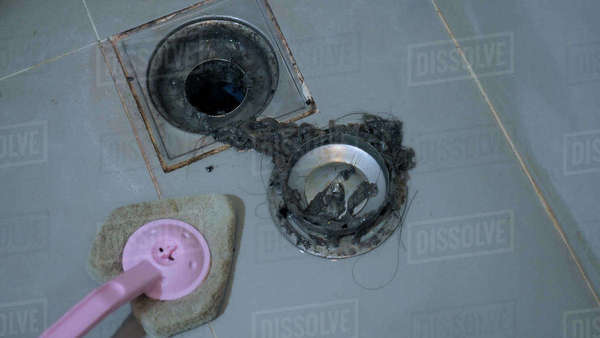 Drain cleaning. Clogged and dirty sewer pipes floor drain. Full of hair ...