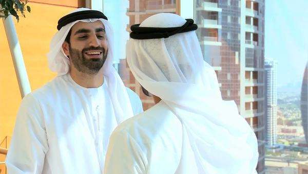 Handshake Emirates UAE male businessmen business traditional dress city ...