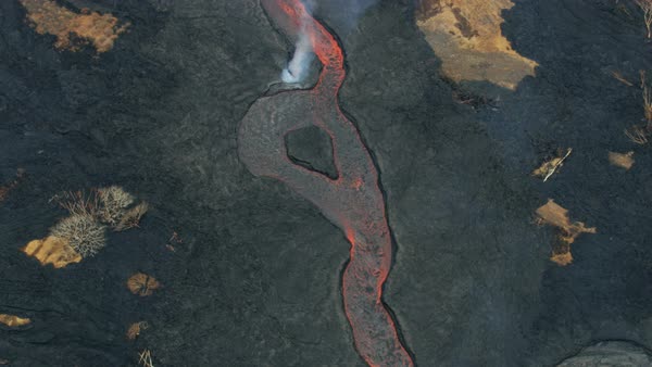 Aerial view of hot liquid flowing lava river lava rock spewing from ...