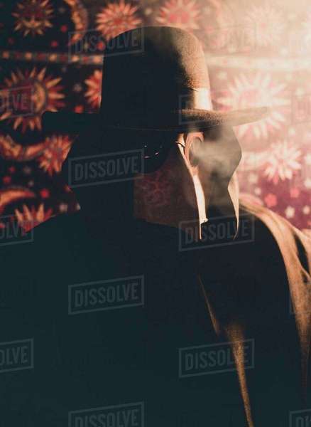 Man with scary mask and black hat - Royalty-free Stock Photo | Dissolve