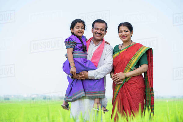 Portrait wide shot of Happy smiling Indian village farming couple with ...