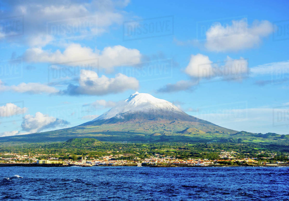 Mount Pico volcano western slope and town of Madalena viewed from ocean ...