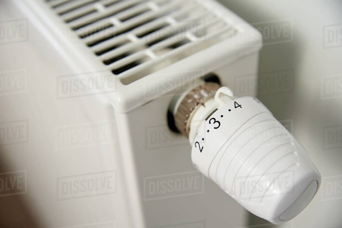 Adjusting temperature on heating radiator thermostat, Turning heat ...