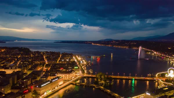 Geneva cityscape with lake, houses, buildings and traffic at sunset and ...