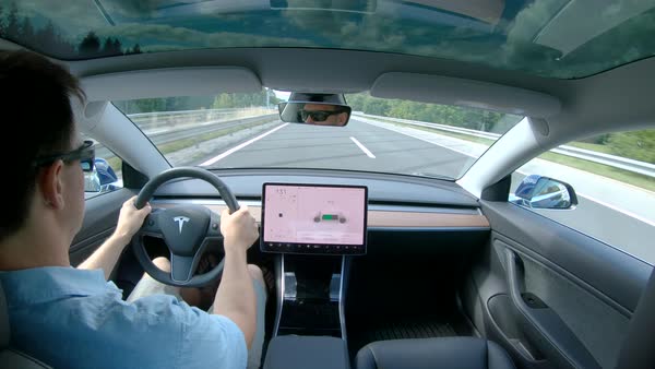 TESLA AUTONOMOUS ELECTRIC CAR, MAY 2019: CLOSE UP: Young Caucasian man ...