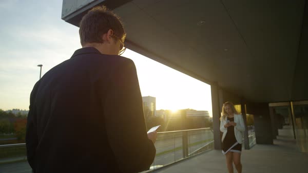 Business people bumping into each other while using smartphones in ...