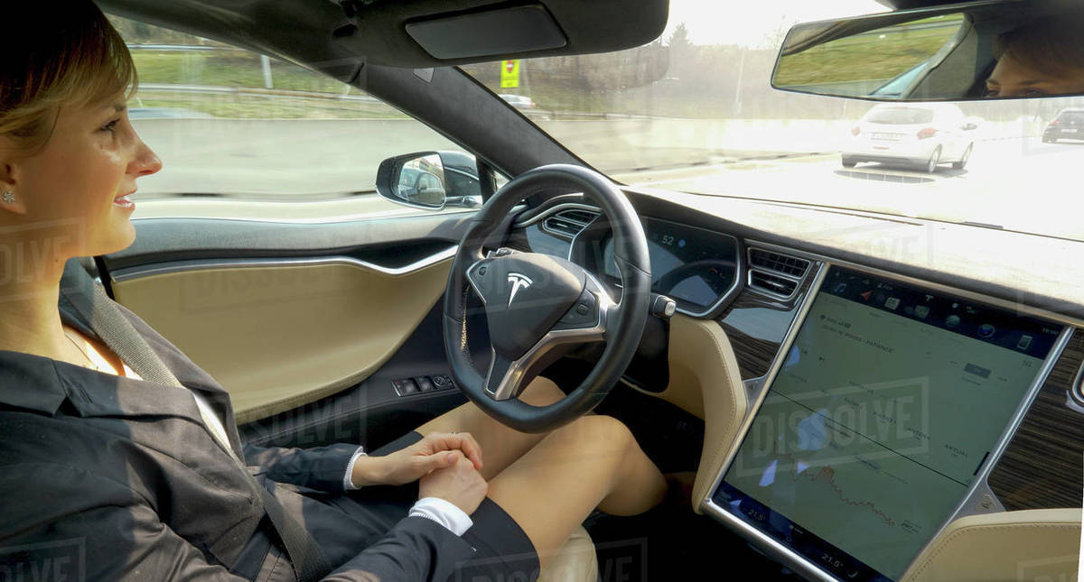 AUTONOMOUS TESLA CAR, MARCH 2018 - CLOSE UP: Young well dressed woman ...