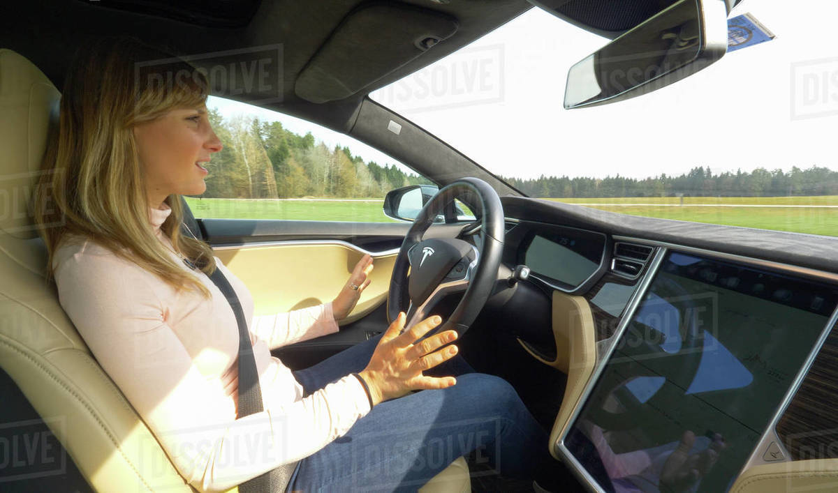 TESLA AUTONOMOUS CAR, March 2018 - CLOSE UP: Woman driving in ...