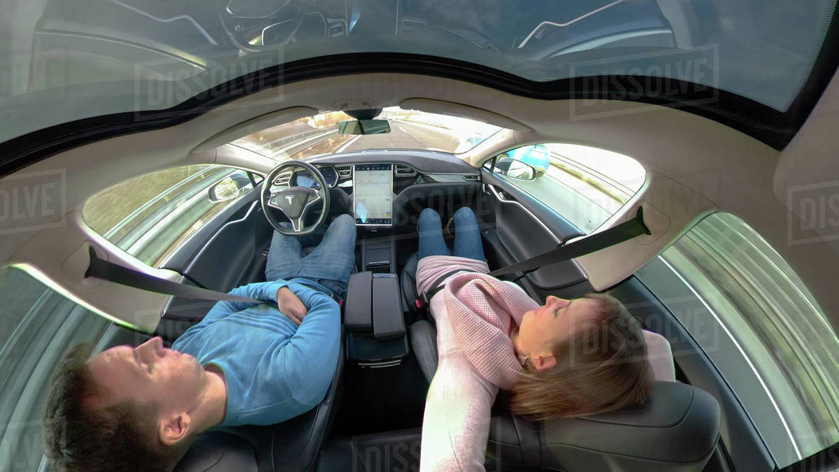 TESLA AUTONOMOUS CAR, March 2018 - CLOSE UP: Young couple sleeps while ...