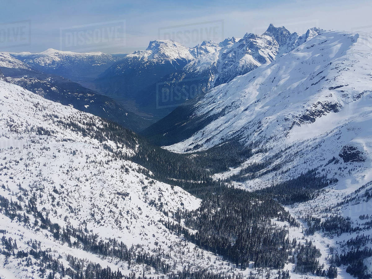 DRONE: Scenic shot from above of beautiful snowy valley in the vast ...
