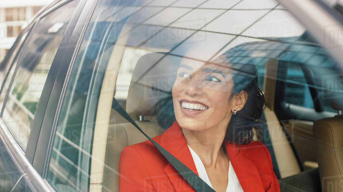 Beautiful Young Woman Rides on a Passenger Seat of a Car, Looks in ...