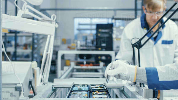 Shot of an Electronics Factory Workers Assembling Circuit Boards by ...