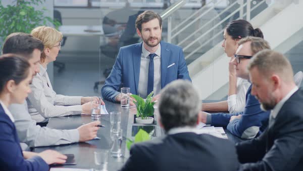 In the modern corporate office meeting room: diverse group of ...