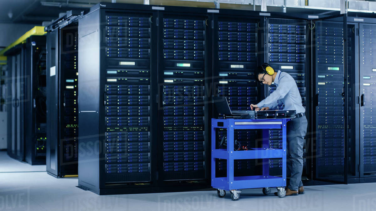 In Data Center: IT Engineer Wearing Protective Muffs Installs New ...