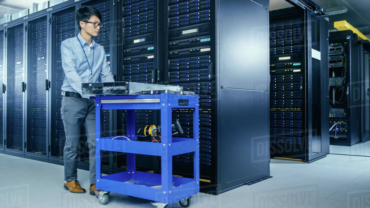 In the Modern Data Center: IT Technician Working with Server Racks ...