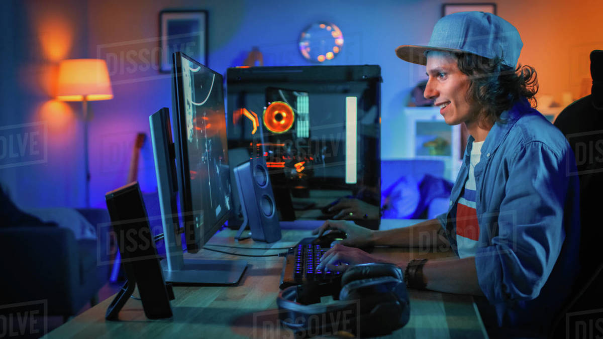 Professional gamer playing first-person shooter online video game on ...