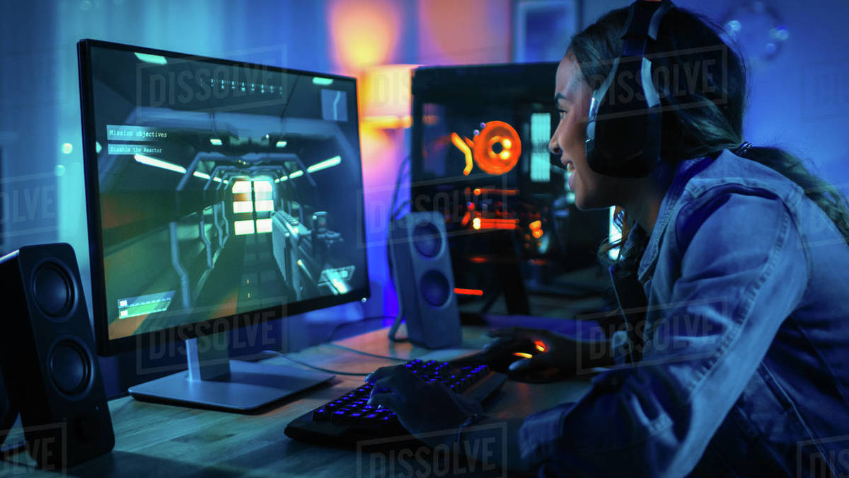 Pretty and excited black blogger girl in headphones is playing first ...