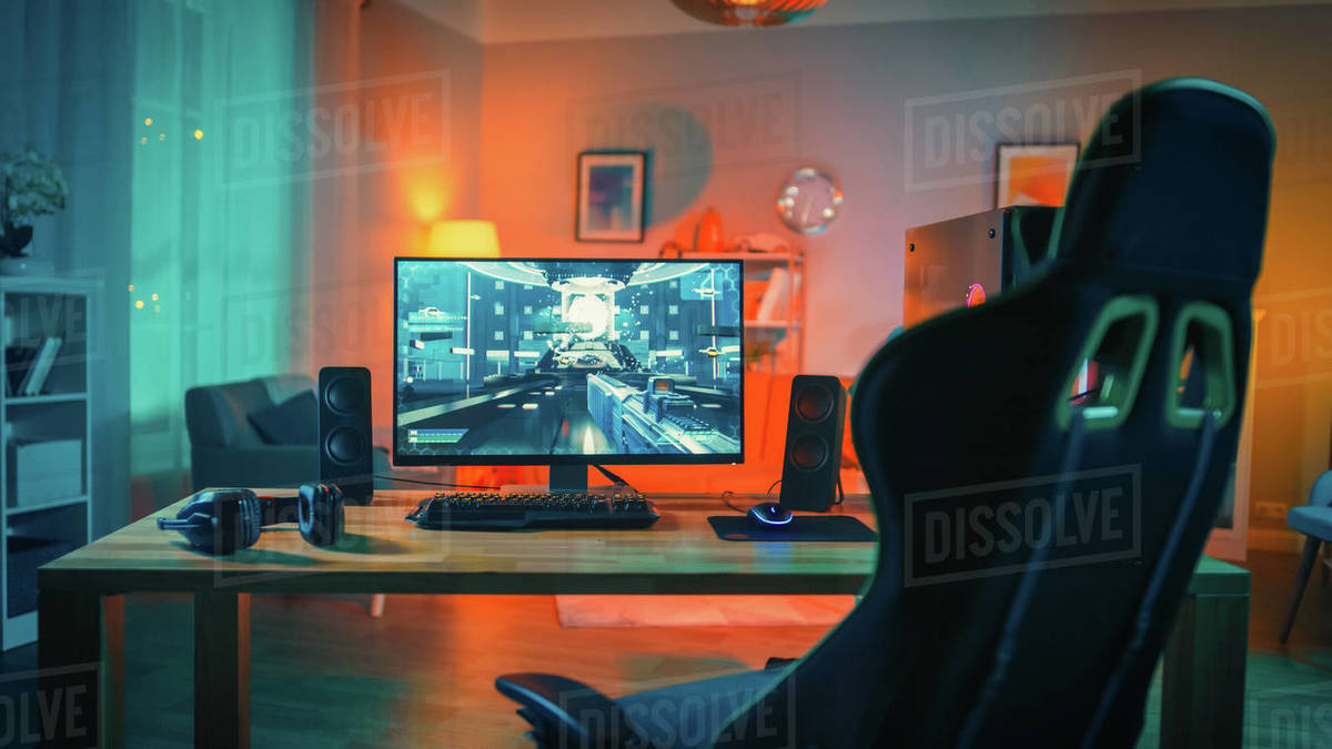 Powerful personal computer gamer rig with first-person shooter game on ...