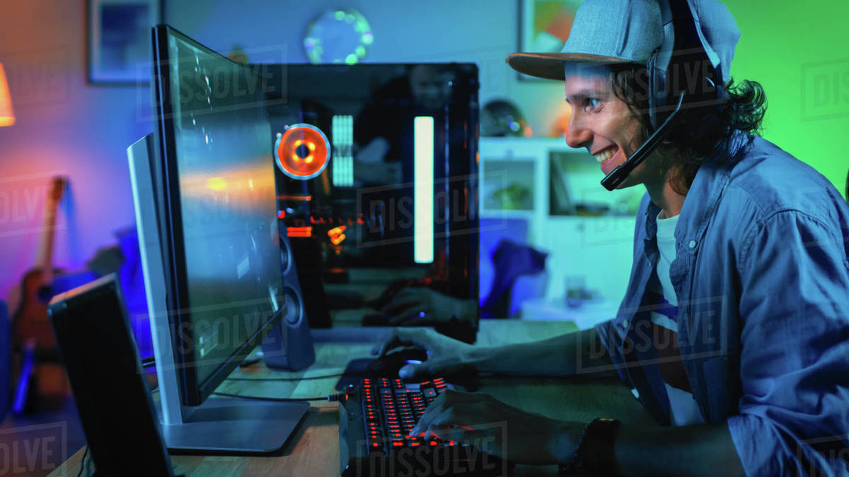 Professional gamer playing first-person shooter online video game on ...