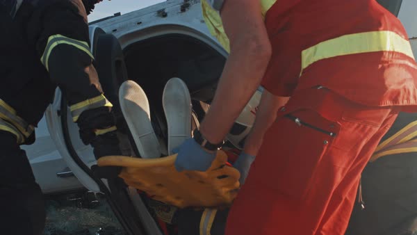 Rescue team of firefighters pull female victim out of rollover vehicle ...