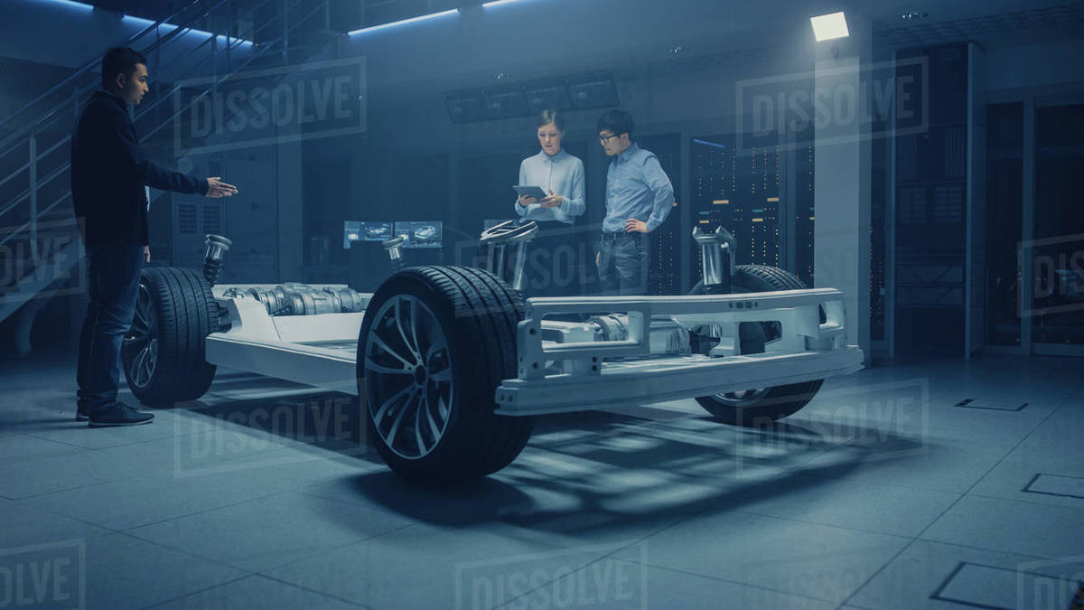 Automobile Design Engineers Talking while Working on Electric Car ...