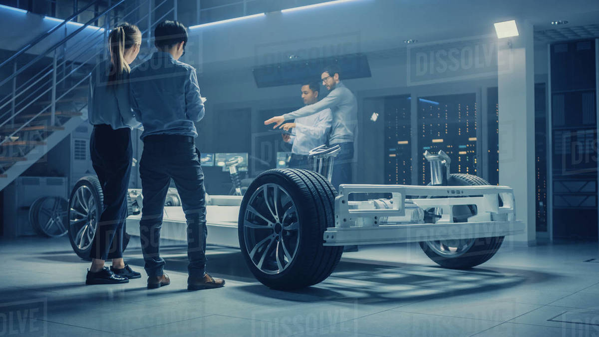 Team of Automotive Engineers Discussing and Designing Electric Car ...