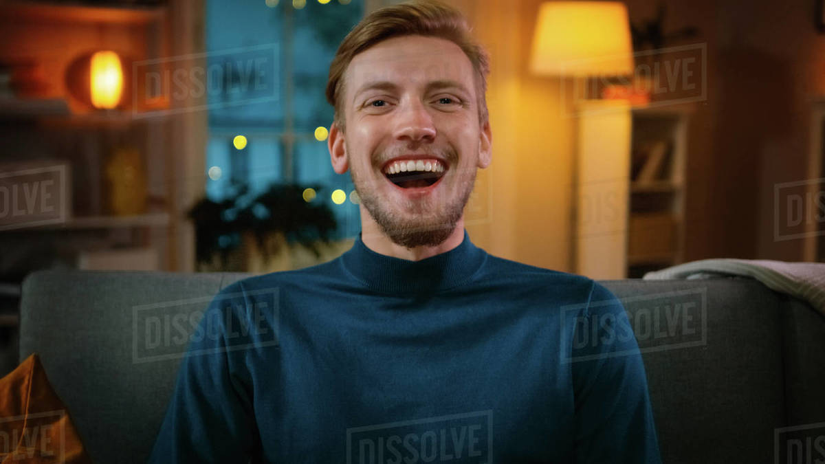 Portrait of a Handsome Man Sitting on a Couch at Home at Night ...
