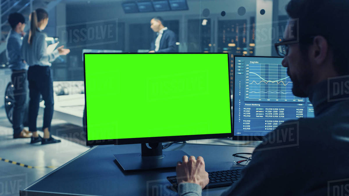 Professional Engineer Works on a Computer with Green Screen Mock Up and ...