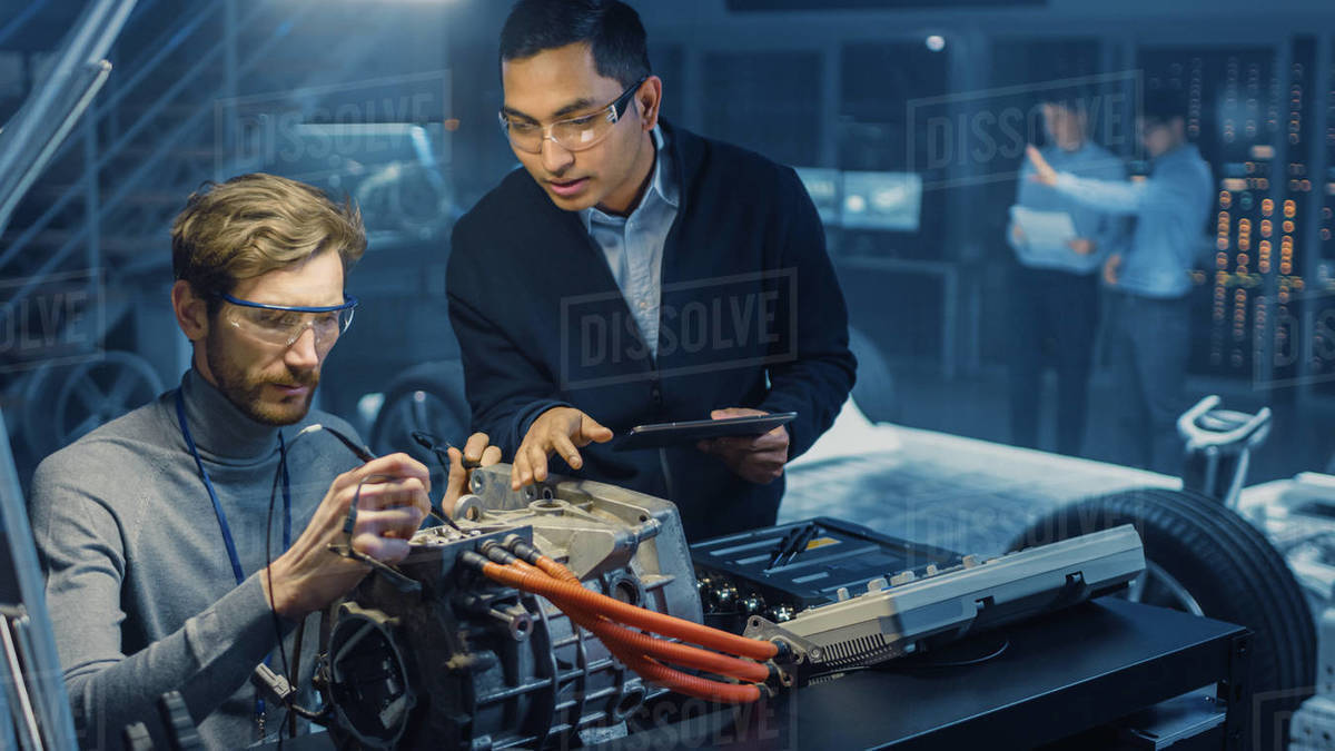 Two Professional Automotive Engineers with a Tablet Computer and ...