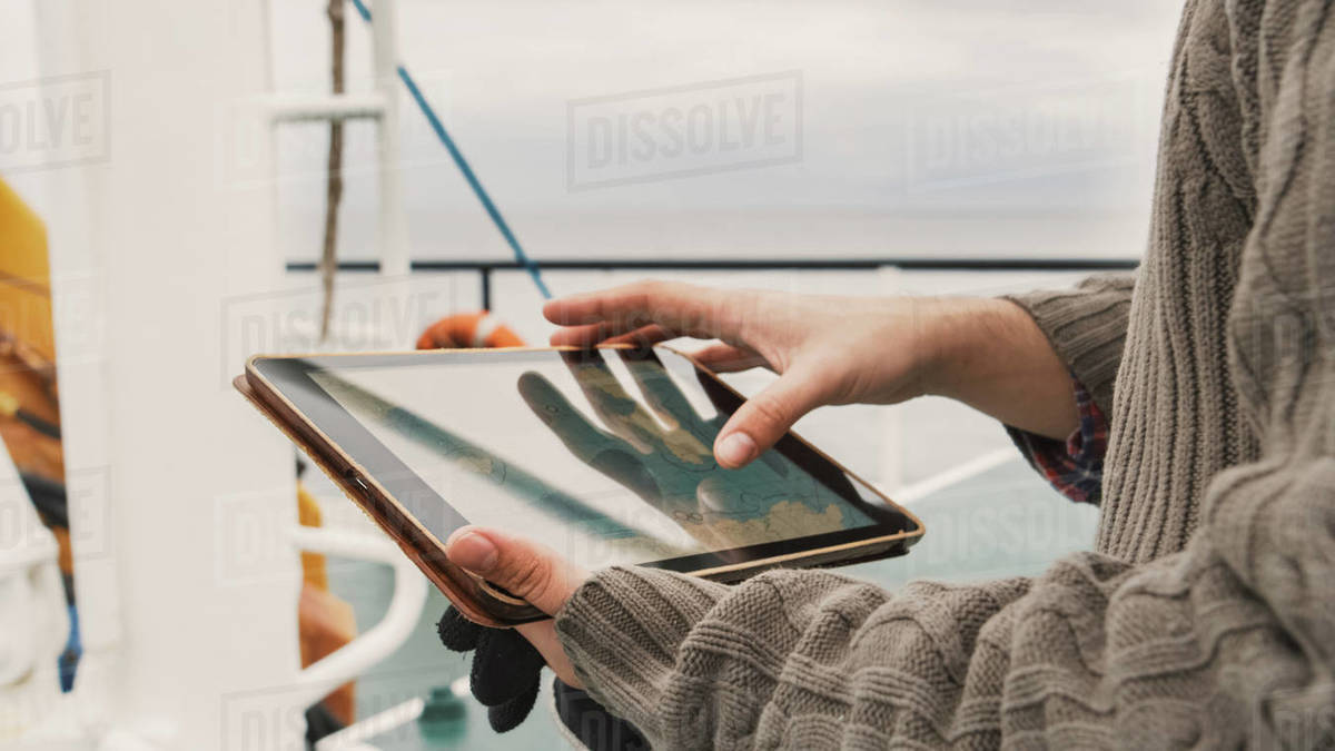 Casually Dressed Fisherman Using Tablet Computer with Navigation Maps ...