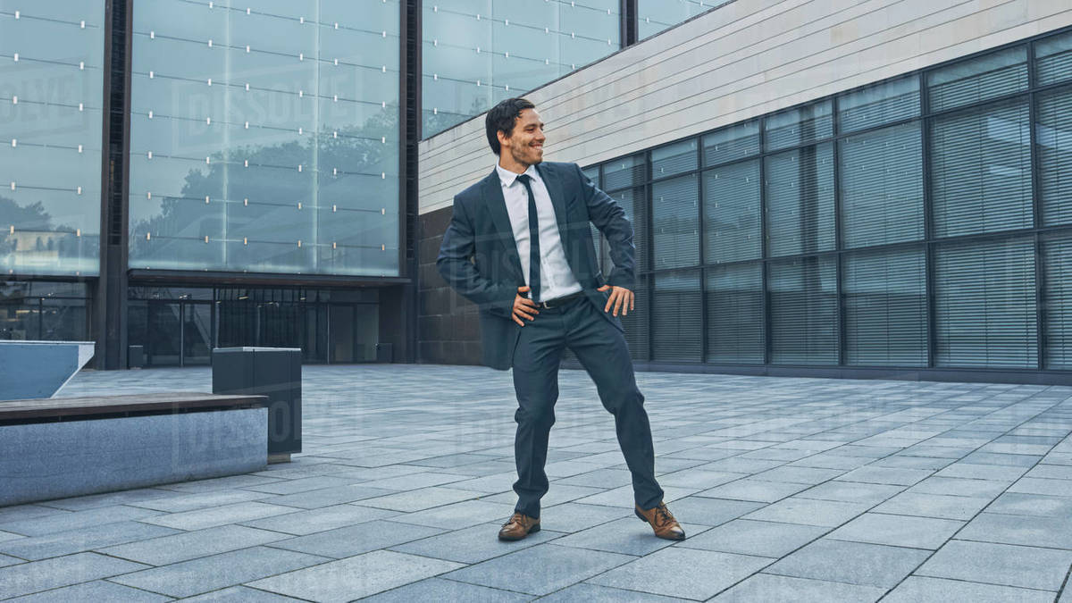 Cheerful and Happy Businessman in a Suit is Actively Dancing on a ...