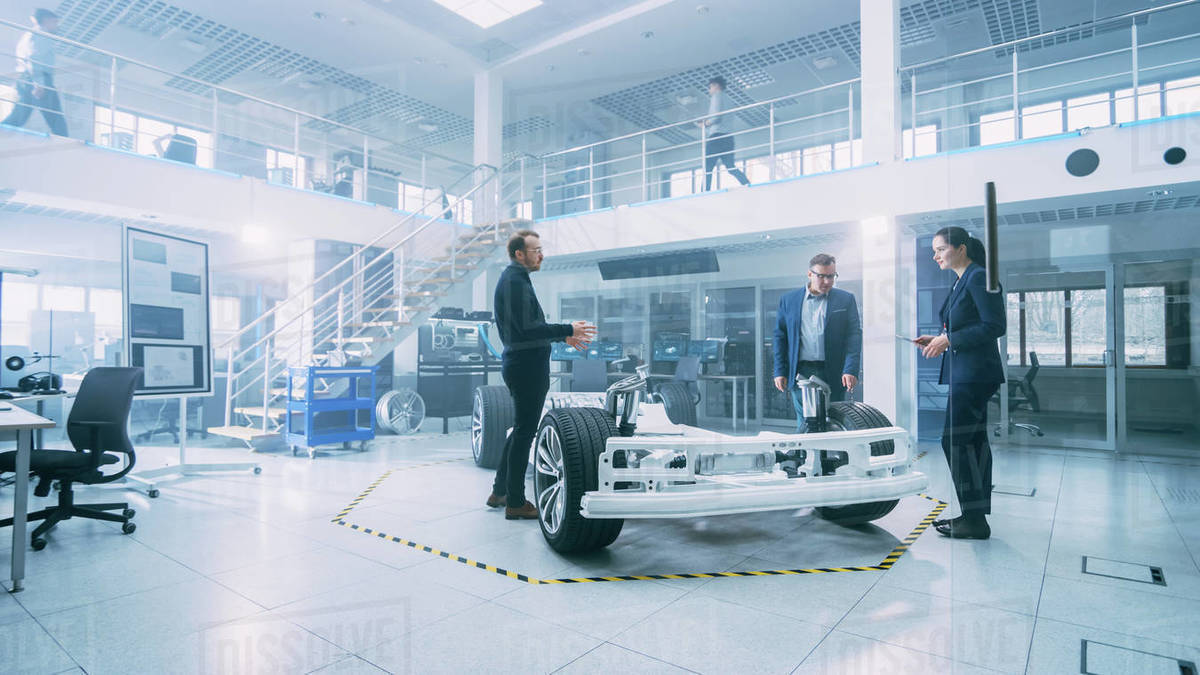 Automotive Design Engineers Talking while Working on Electric Car ...