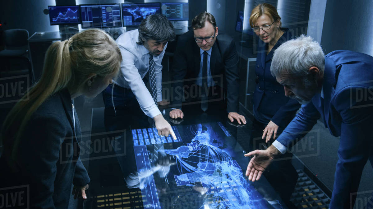 Team of Government Intelligence / FBI Agents Standing Around Digital ...