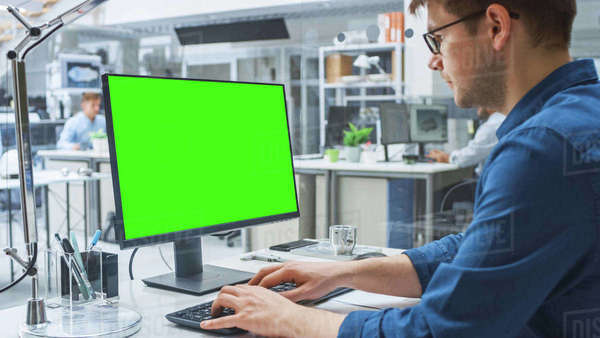 Over the Shoulder Shot of Engineer Working with Green Screen Mock-up ...