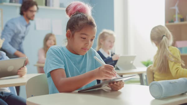 Elementary School Computer Science Class: Cute Girl Uses Digital Tablet ...